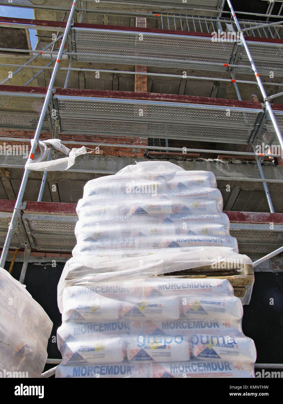 Sacks of finishing materials on building site Stock Photo - Alamy