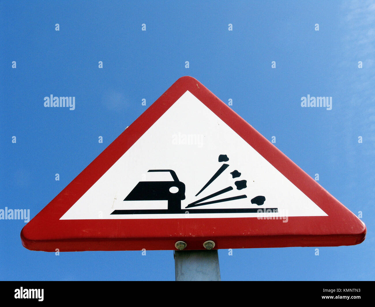 Traffic sign Beware of loose stones or gravel Stock Photo - Alamy