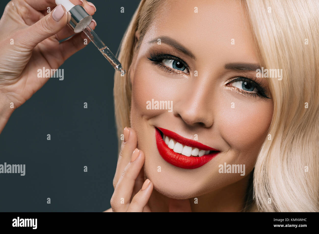 woman applying serum on face Stock Photo - Alamy