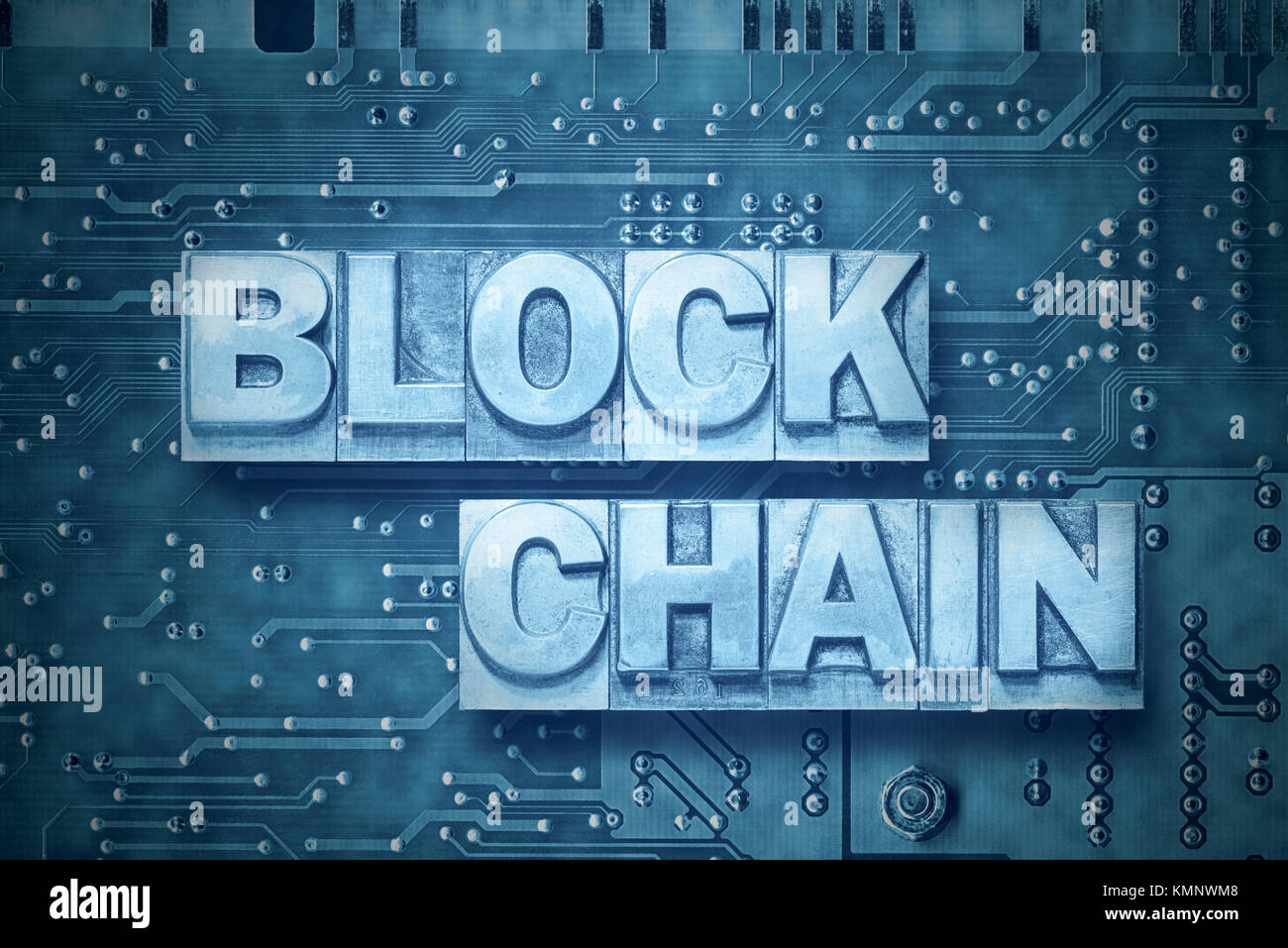 blockchain word made from metallic letterpress blocks on the pc board ...
