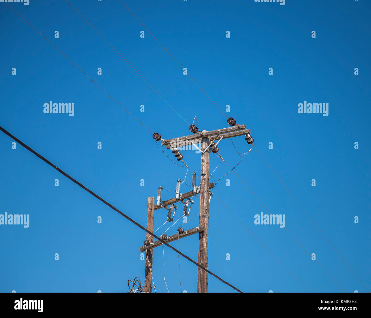 old wire columns on blue sky background Stock Photo - Alamy