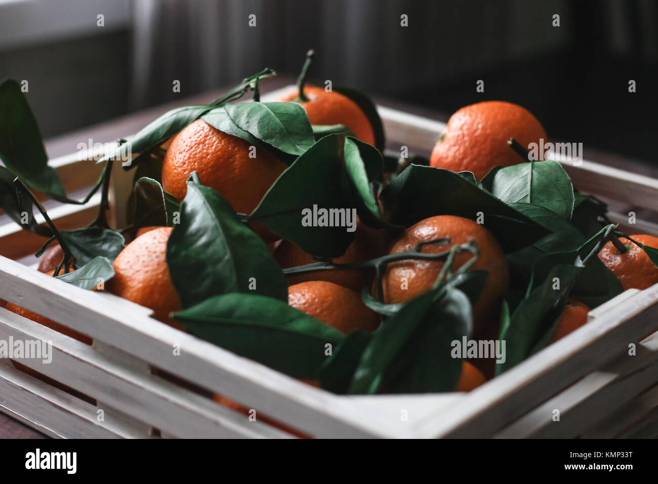 Wooden box of fresh tangerines with leaves Stock Photo - Alamy