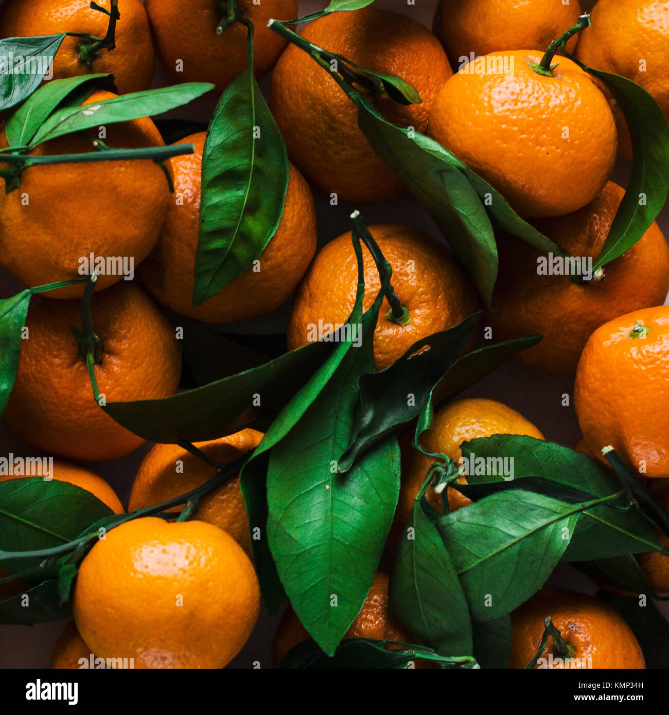 Fresh tangerines with leaves background Stock Photo - Alamy