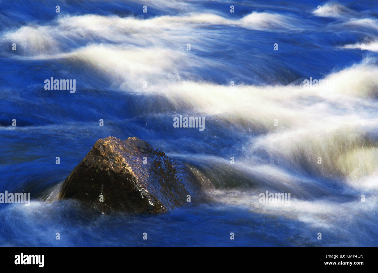Brownish rock in flowing stream, close-up Stock Photo - Alamy