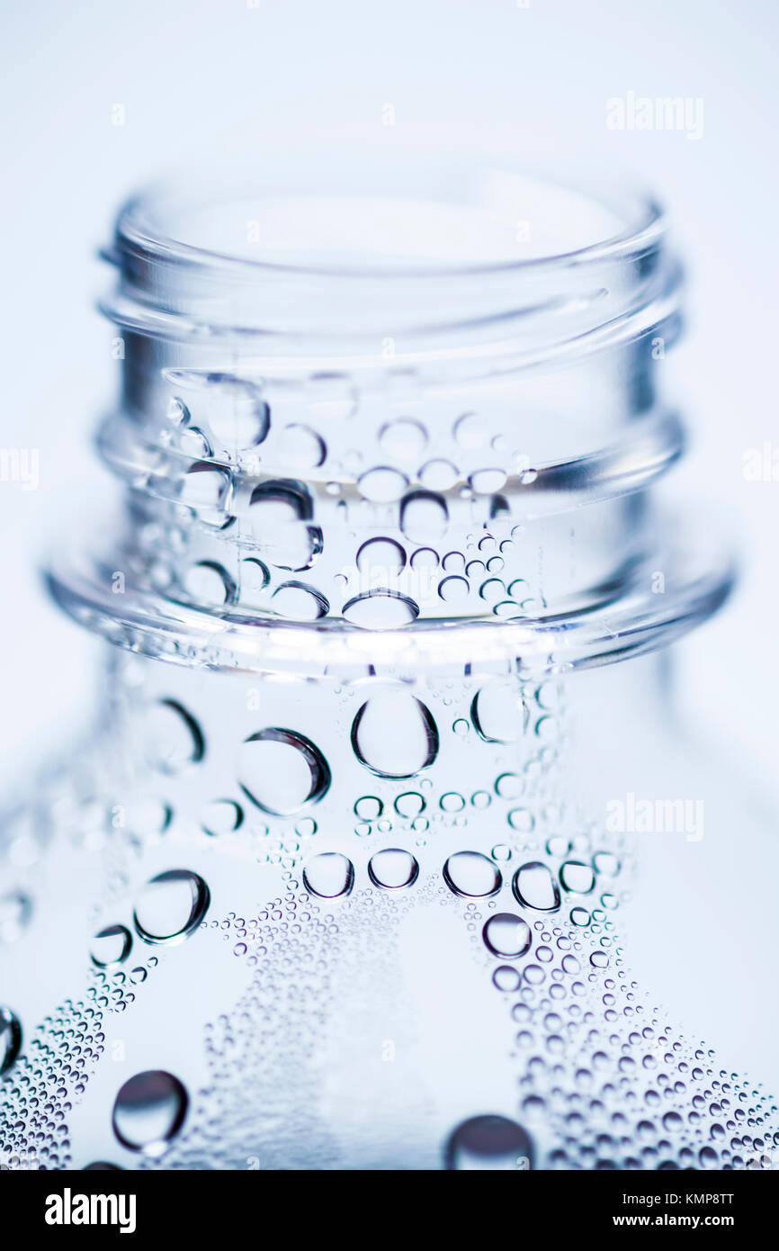 The top of a single use plastic bottle with bubbles / water droplets ...