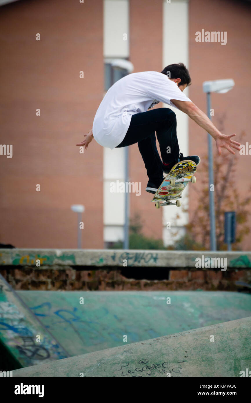 A young boy jumping with skateboard. Imperia, IM, Liguria, Italy ...