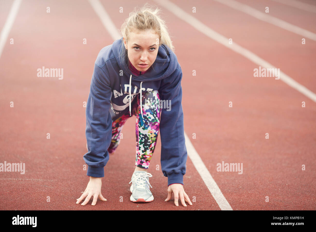 Young girl preparing to run the sports track Stock Photo - Alamy