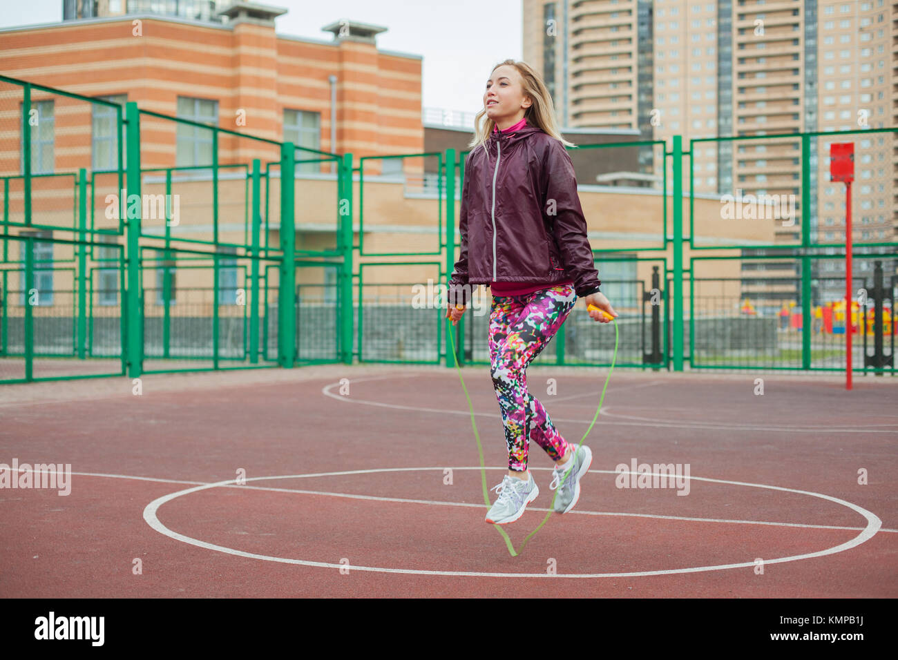 Young fitness woman jumping rope on the Playground Stock Photo - Alamy