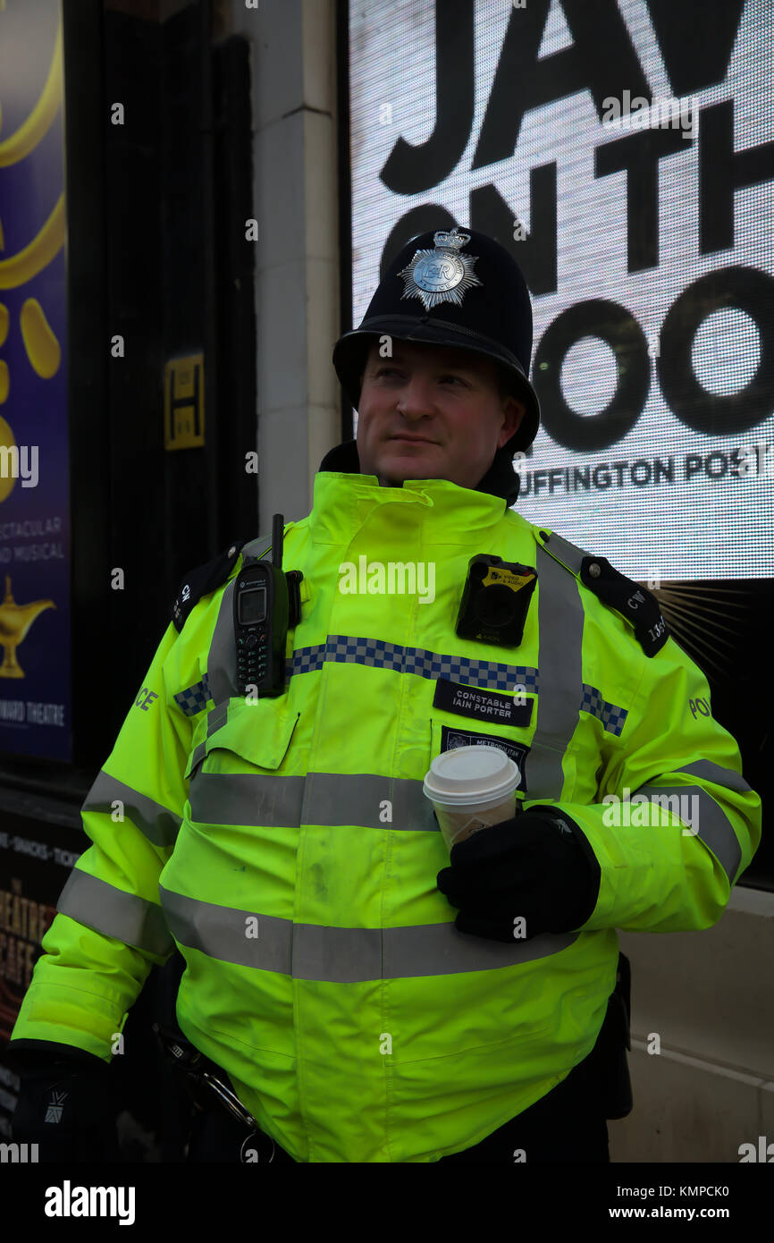 London, UK. 8th Dec, 2017. A police officer drinks a hot drink to stay ...