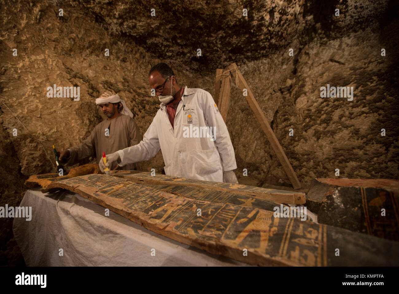 Egyptian archeologists work in a newly discovered tomb in Luxor, Egypt ...