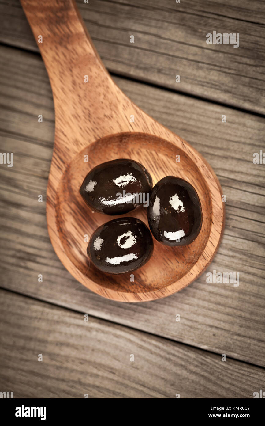 Olives on a wooden table Stock Photo - Alamy
