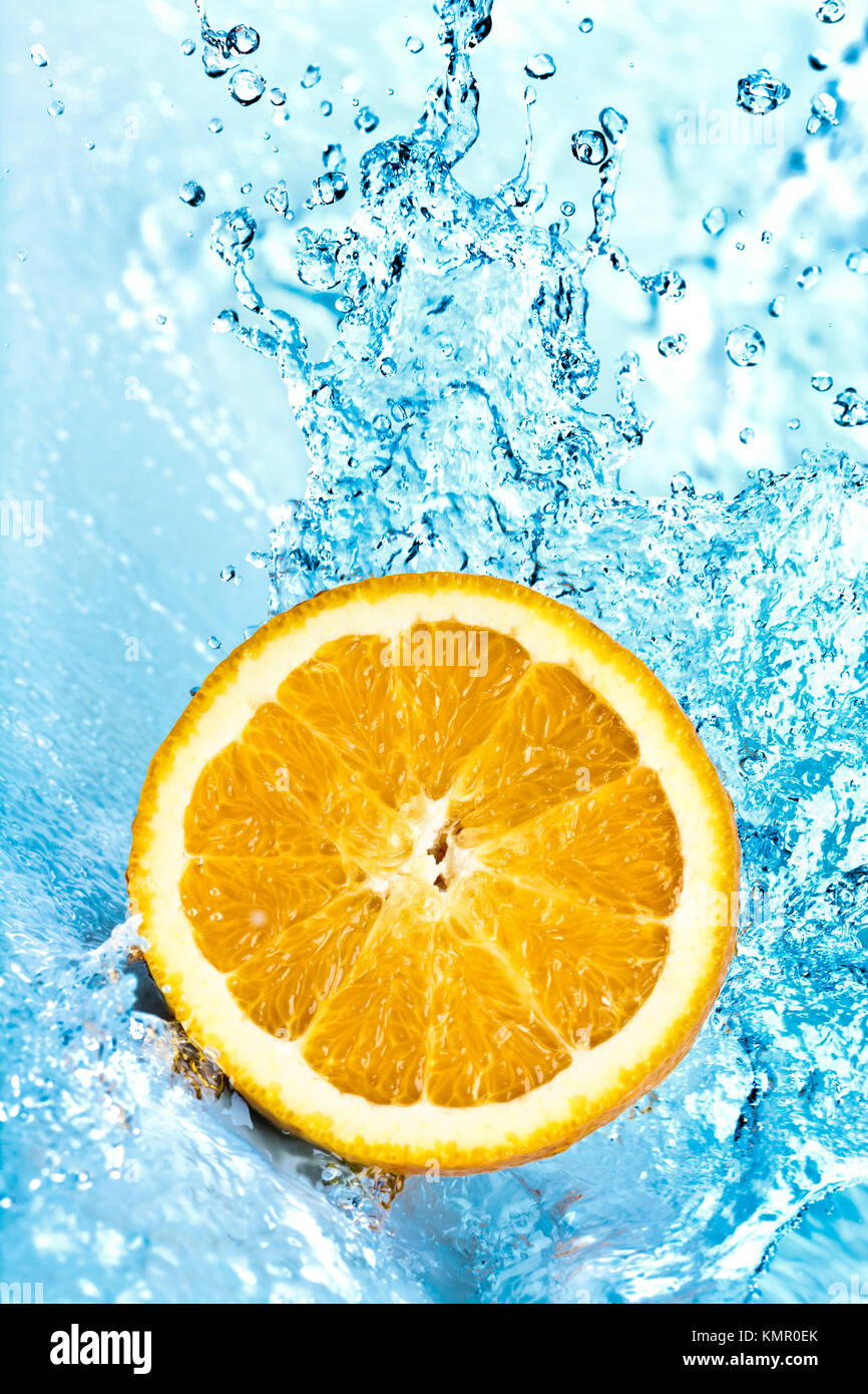 fresh water splash on orange Stock Photo - Alamy