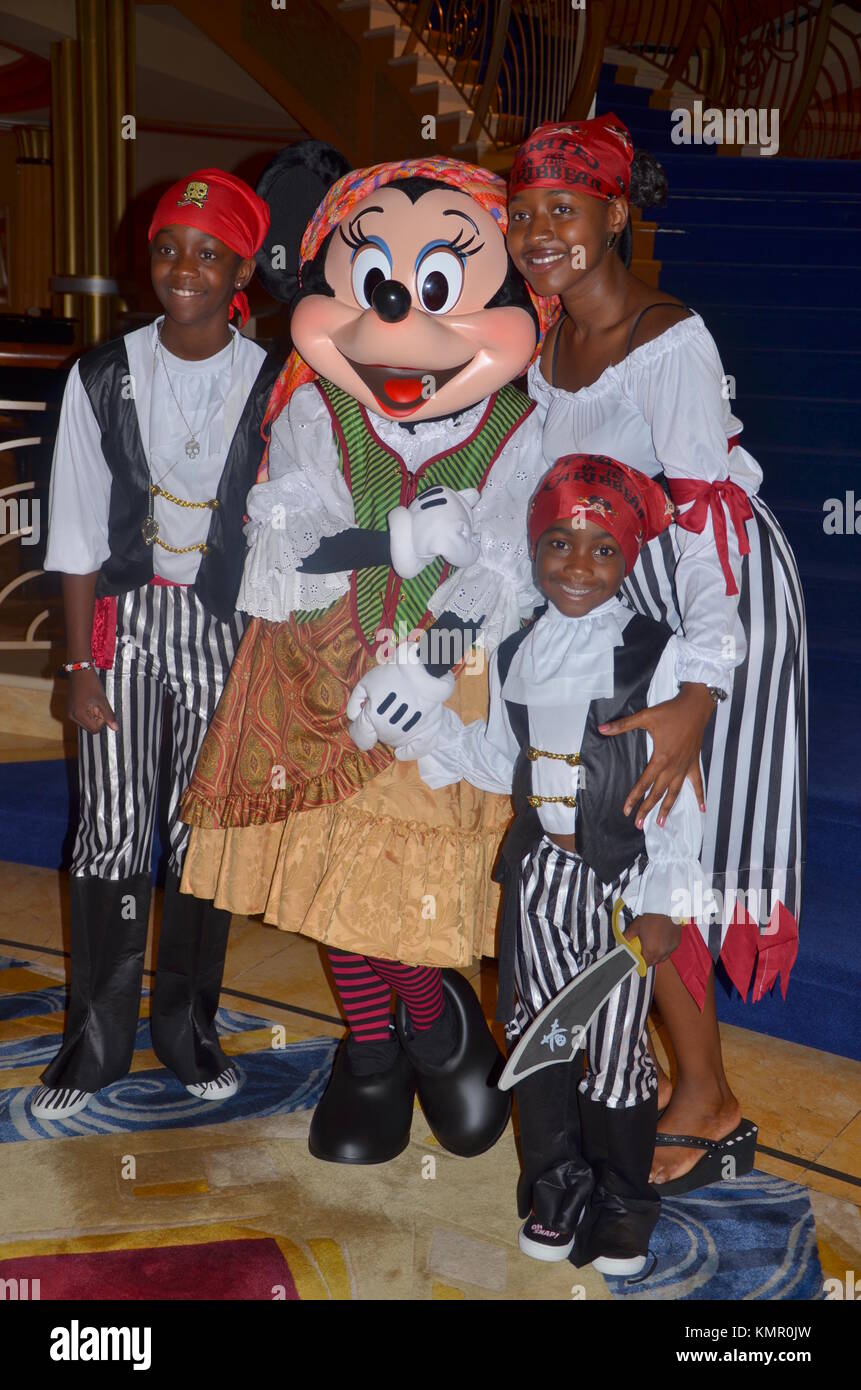 Afro-Caribbean family taking pictures with Minnie Mouse on the Disney ...