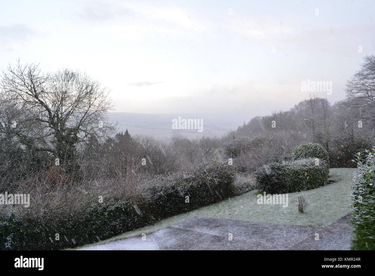 Winter country view with slight snow fall cover from hill side looking ...
