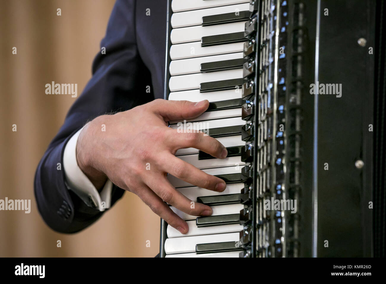 A young musician plays solo on an accordion during a concert Stock ...