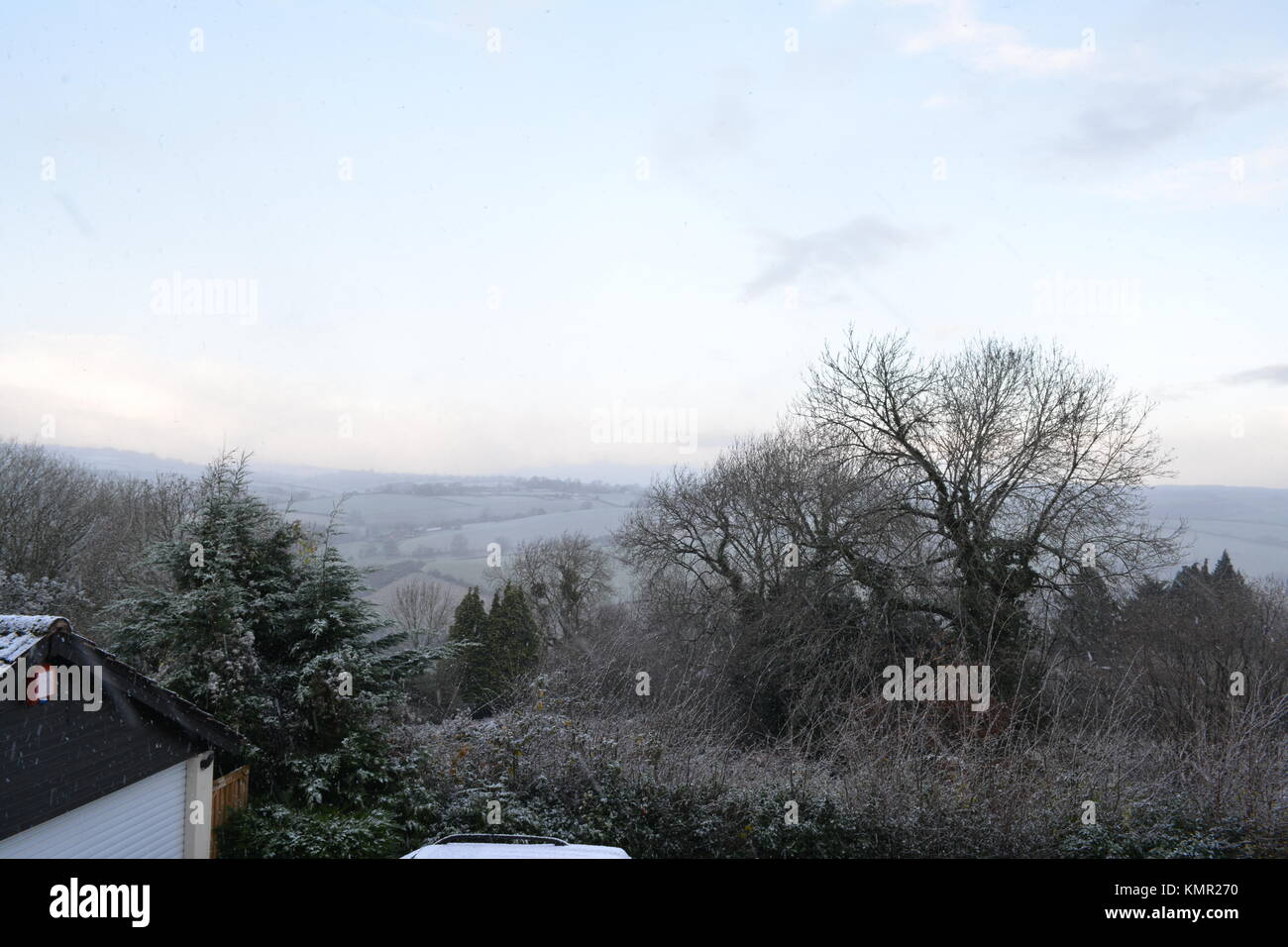 Winter country view with slight snow fall cover from hill side looking ...