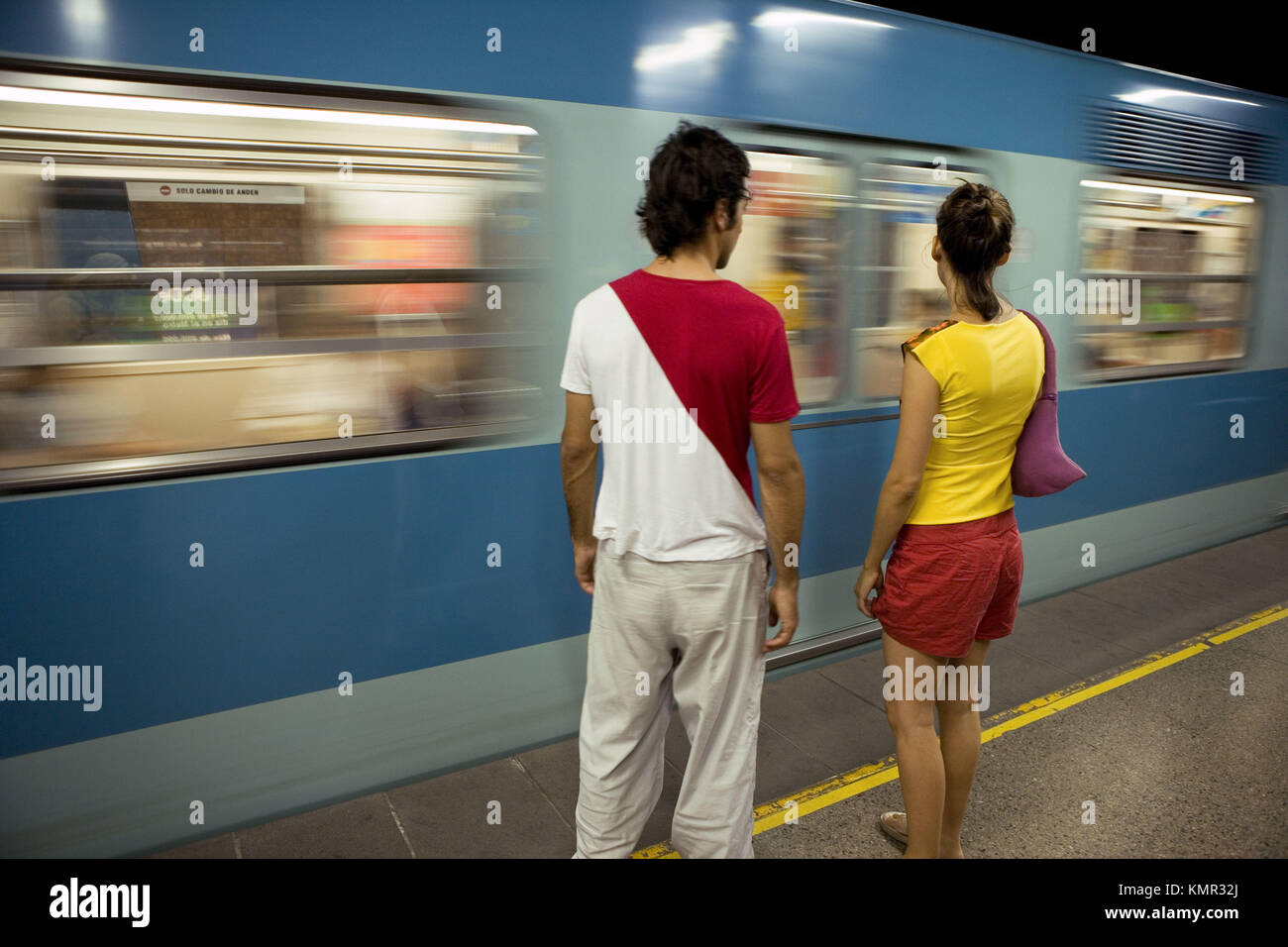 Rear view woman standing subway hi-res stock photography and images - Alamy