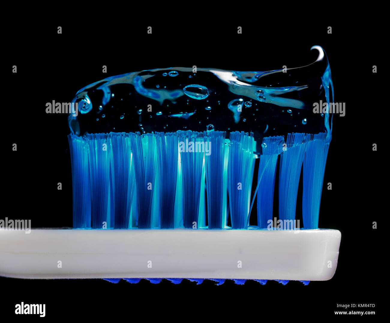 Blue and white toothbrush with transparent toothpaste on contrast with ...