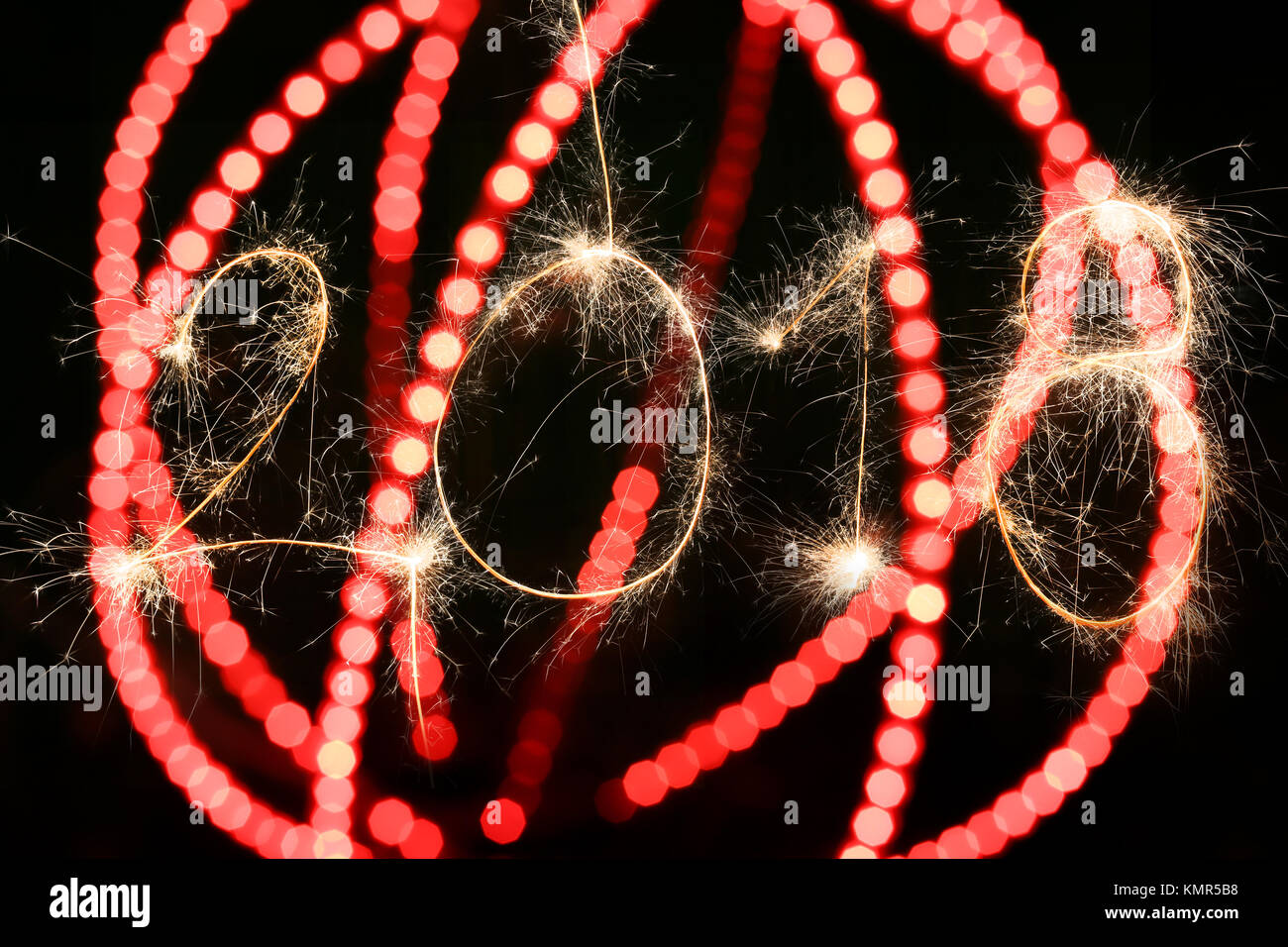 2018 sign written with sparkle firework on black background with ...