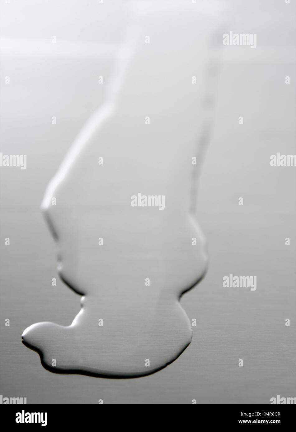Liquid,transparent oil shape on a stainless steel metal surface Stock ...
