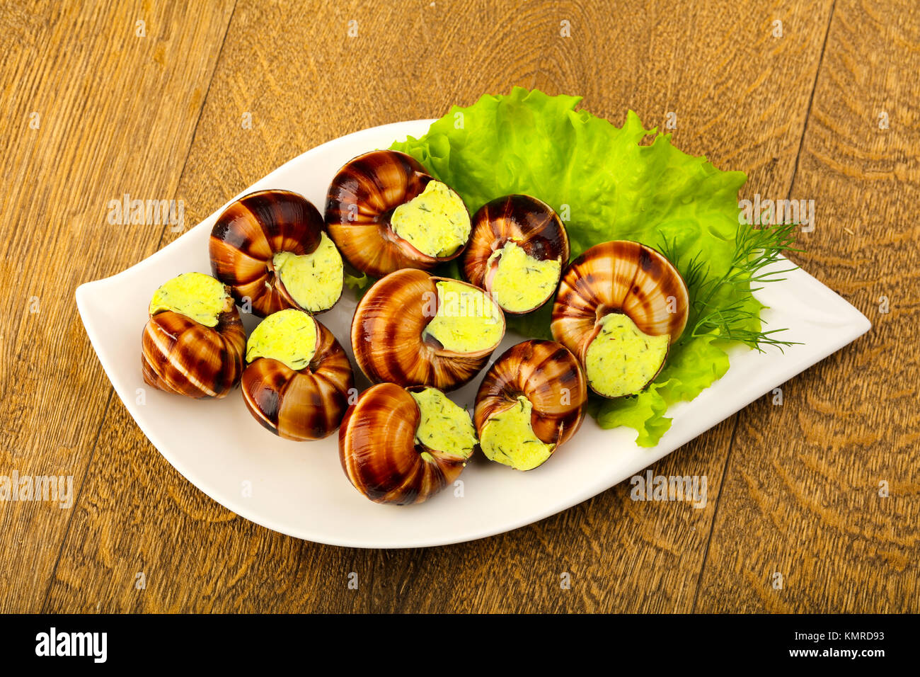 Escargot with cheese cream on salad leaves Stock Photo - Alamy
