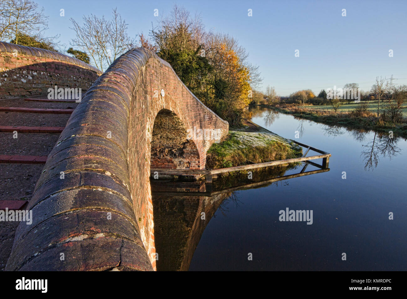 canal bridge arch at Lapworth junction showing canal and reflections ...