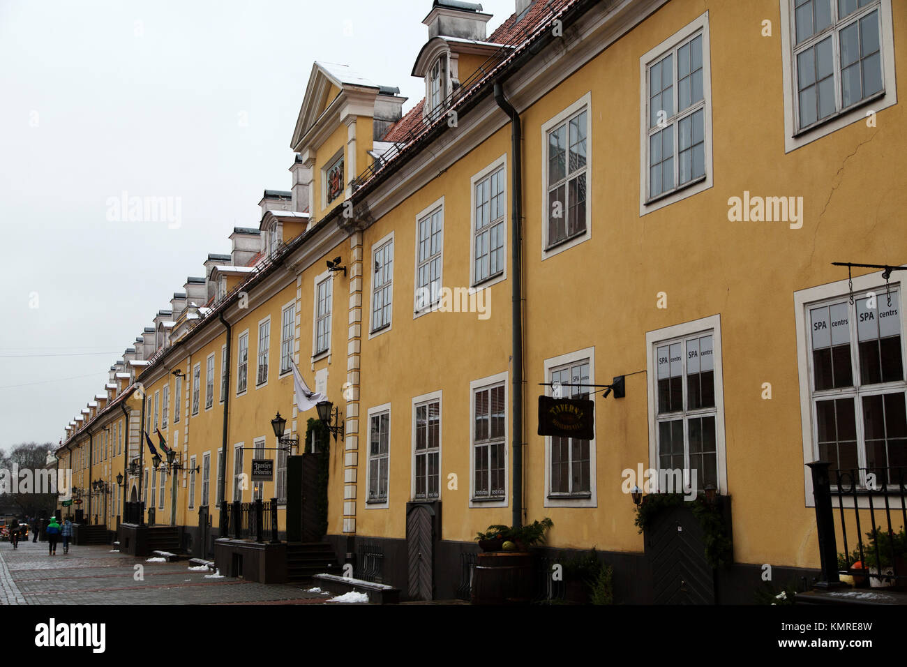 Yellow facades of buildings on Torna iela in Riga, Latvia. Businesses ...