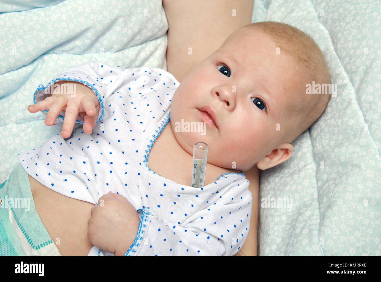 Measurement of a body temperature to the ill child of 4 months Stock ...