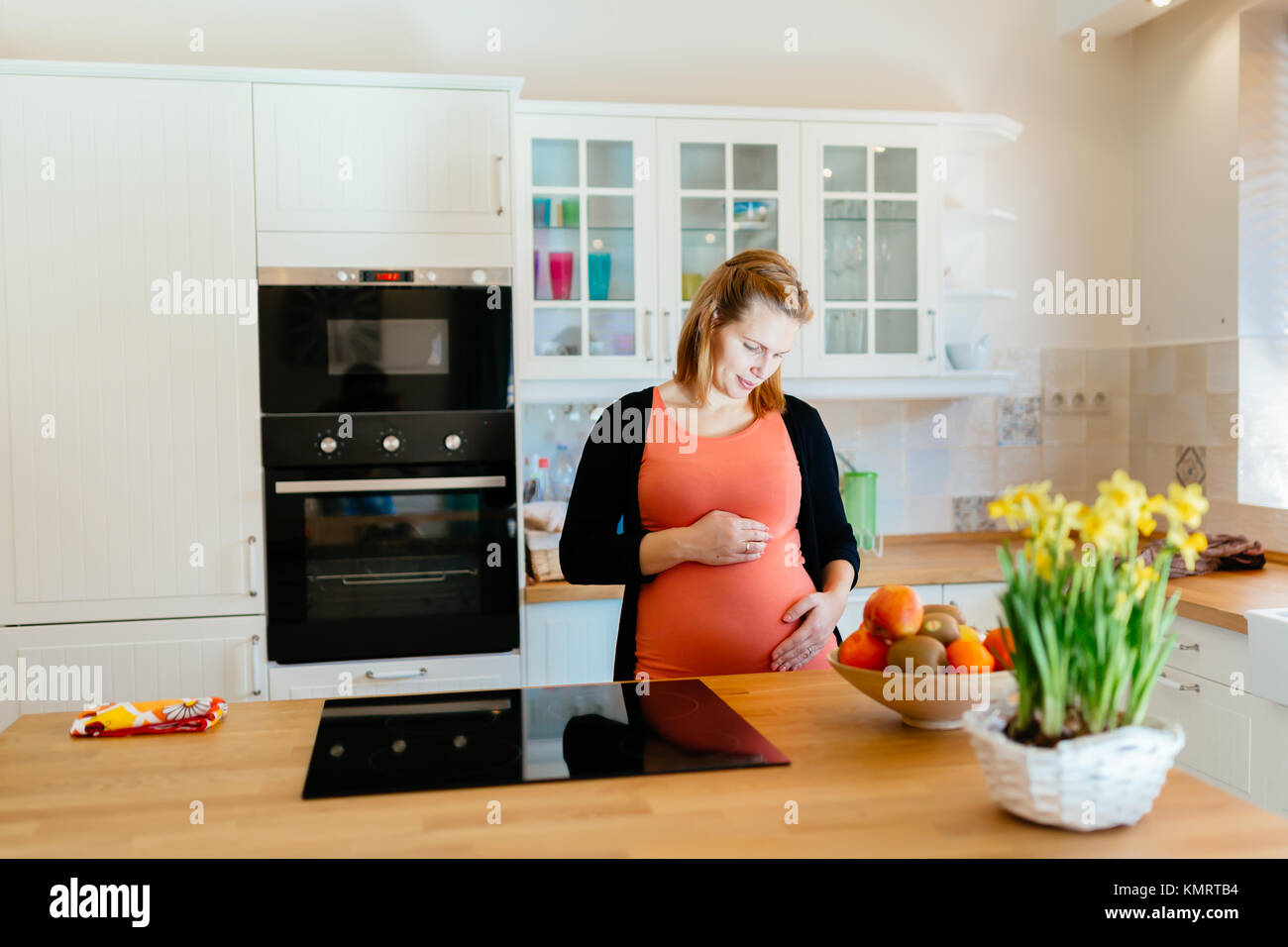 Beautiful pregnant woman in kitchen Stock Photo - Alamy