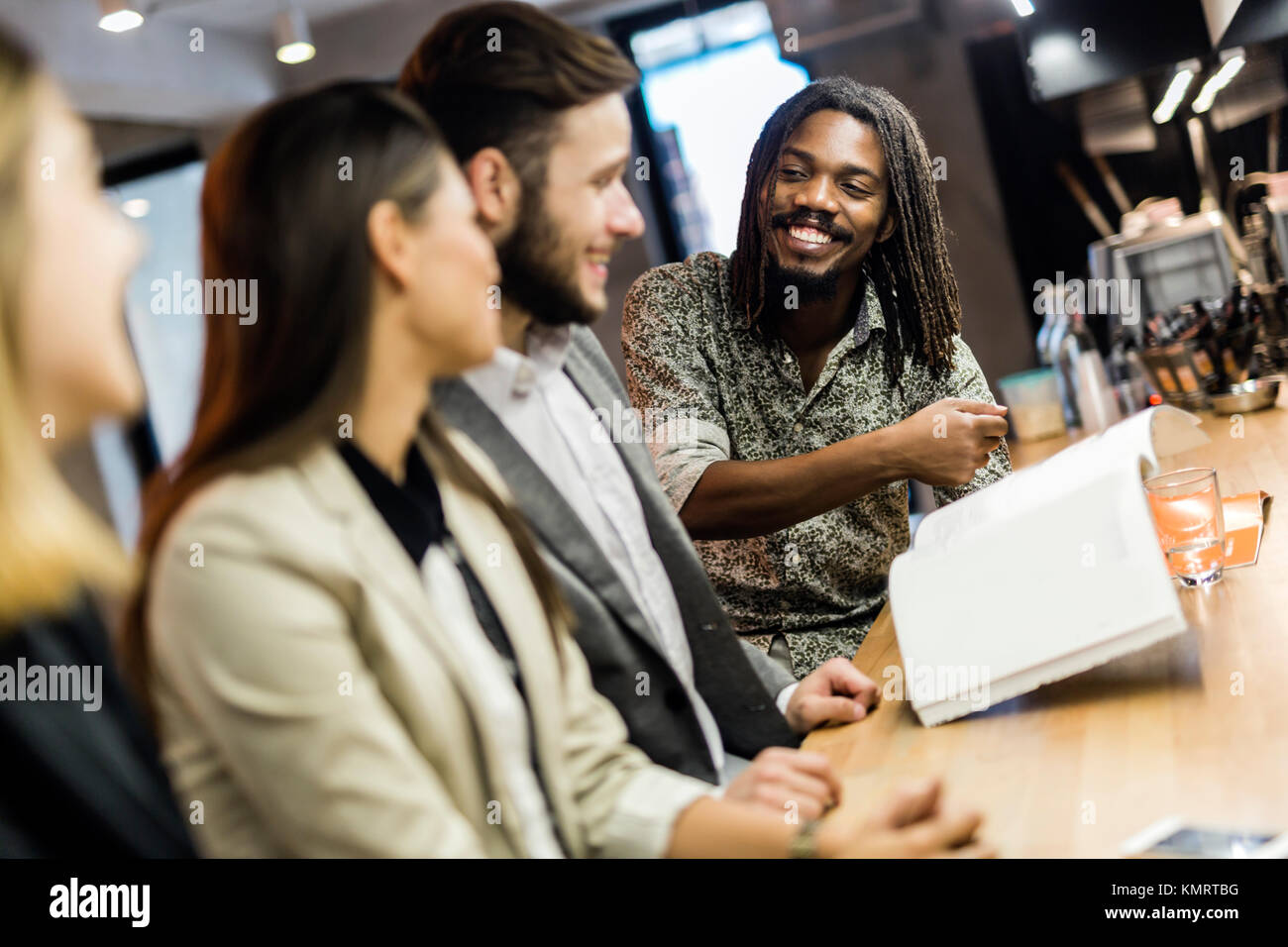 Friends at the counter of a bar after work Stock Photo - Alamy