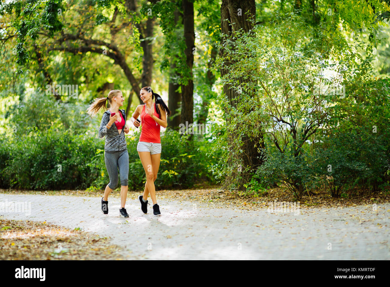 Young fit women jogging outdoors Stock Photo - Alamy