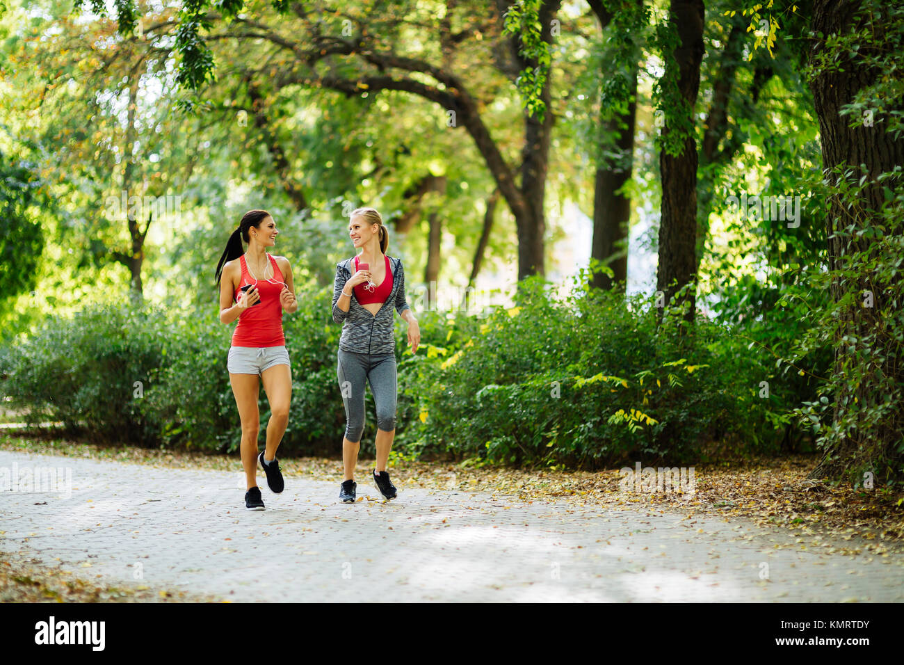 Beautiful sporty women jogging Stock Photo - Alamy