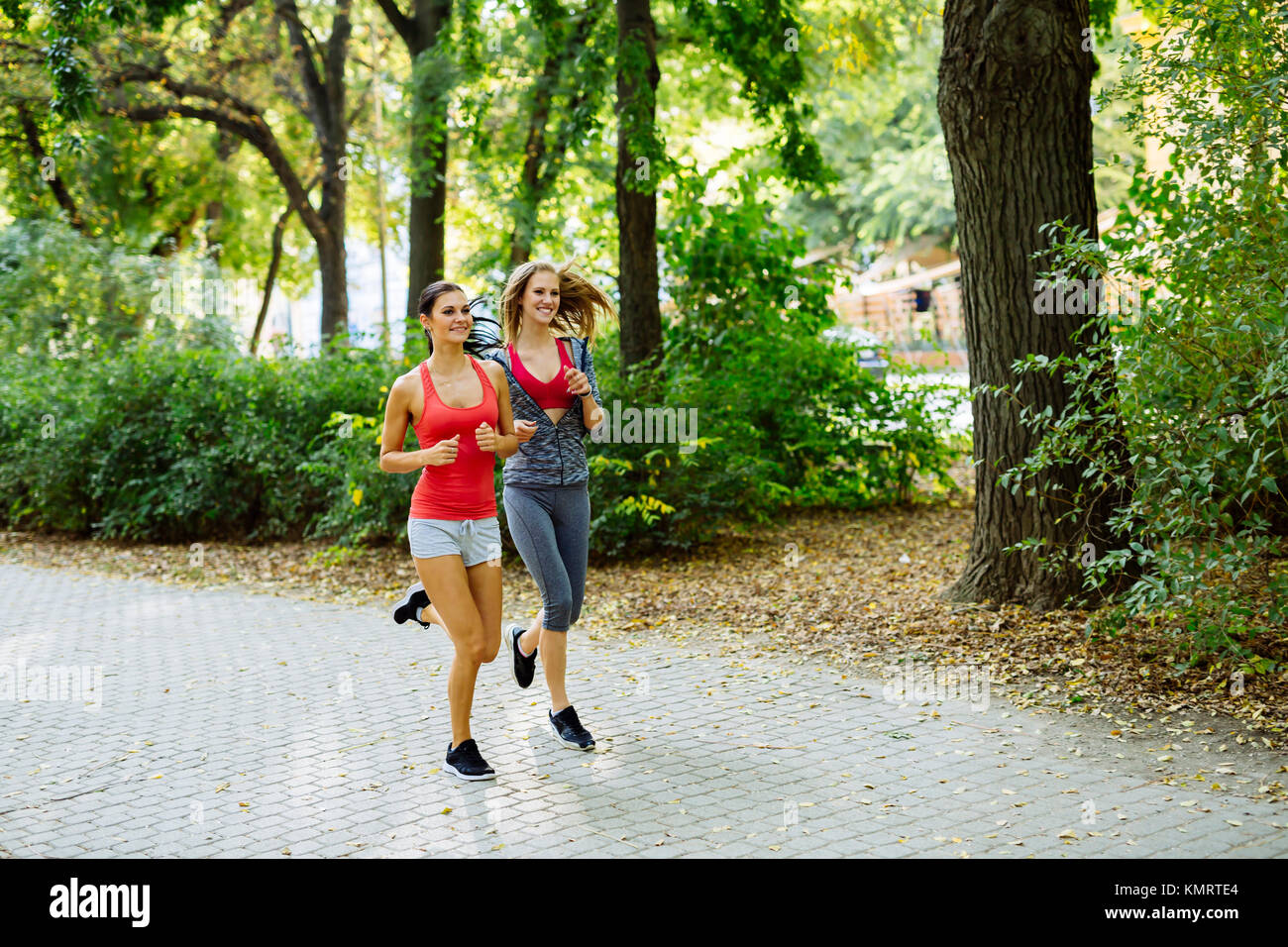 Young fit women jogging outdoors Stock Photo - Alamy