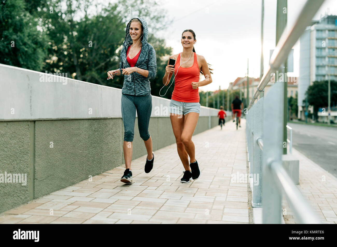 Two women exercising by jogging Stock Photo - Alamy