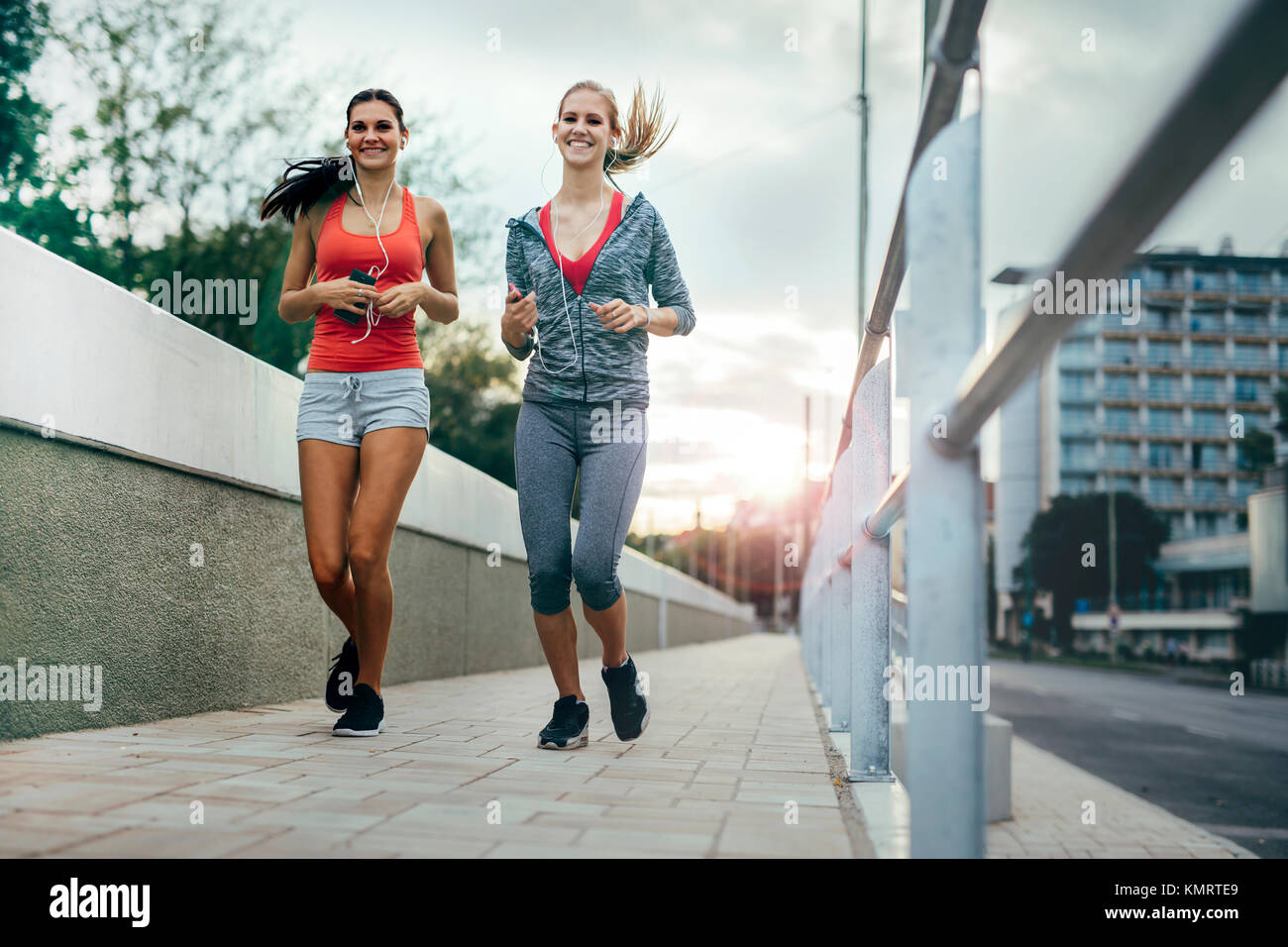 Two women exercising by jogging Stock Photo - Alamy