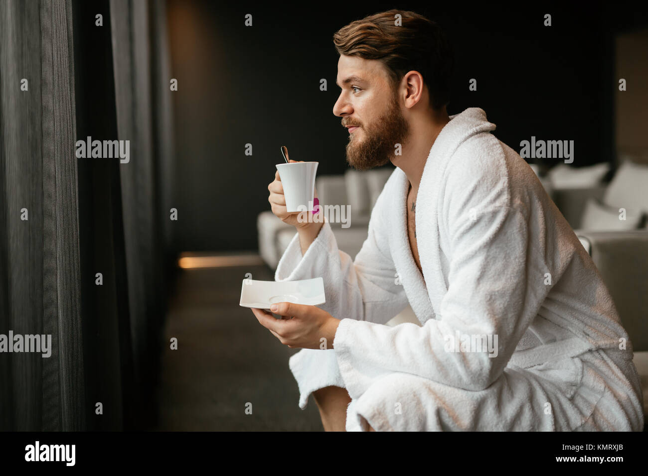 Handsome man drinking tea Stock Photo - Alamy