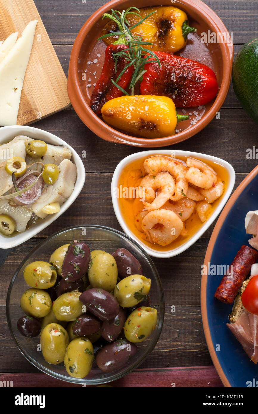 Sharing mixed spanish tapas starters on table. Top view Stock Photo - Alamy