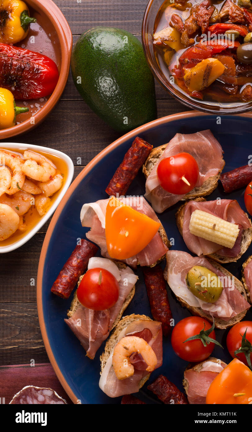 Sharing mixed spanish tapas starters on table. Top view Stock Photo - Alamy