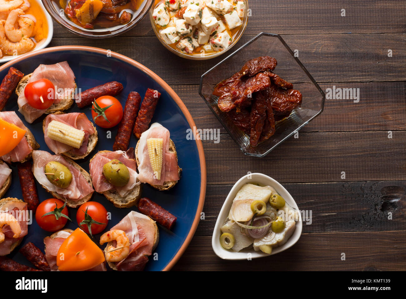 Sharing mixed spanish tapas starters on table. Top view. Copyspace ...