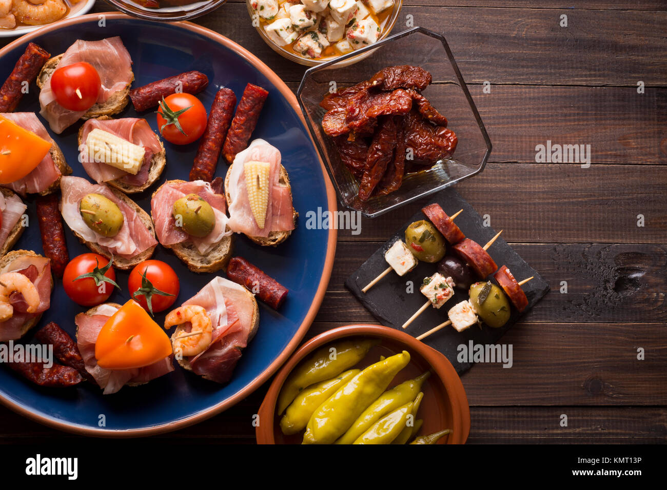 Sharing mixed spanish tapas starters on table. Top view. Copy space ...