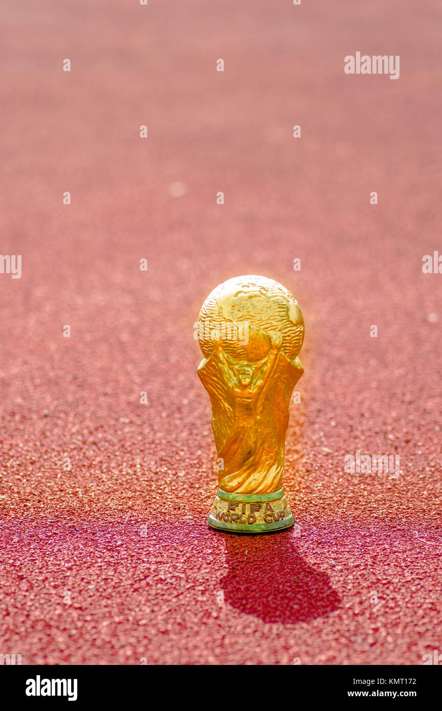 Close up of fake golden trophy in the form of the globe over a red ...