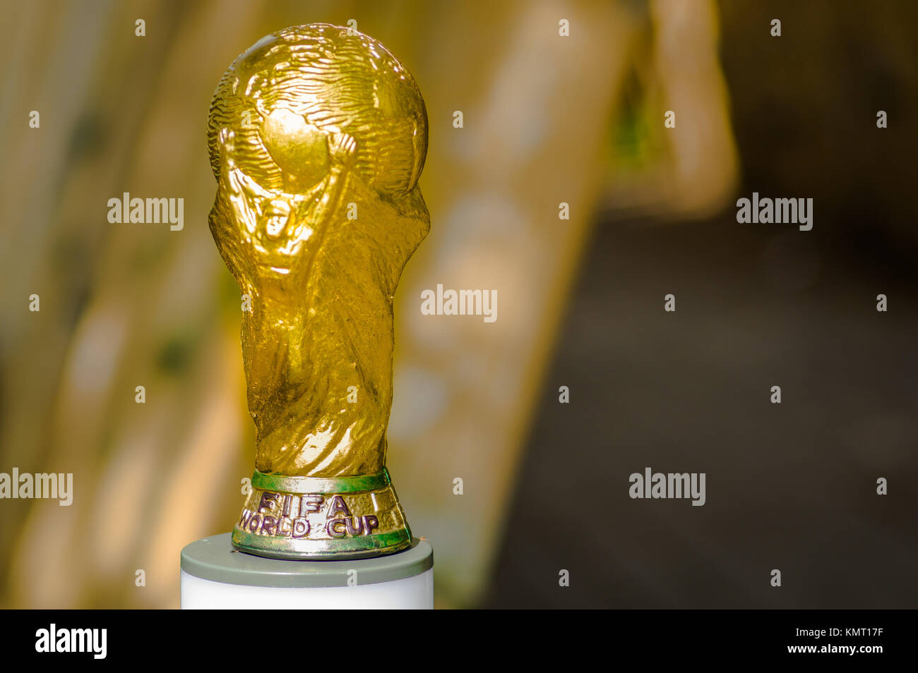 Close up of of fake golden trophy in the form of the globe in a blurred ...