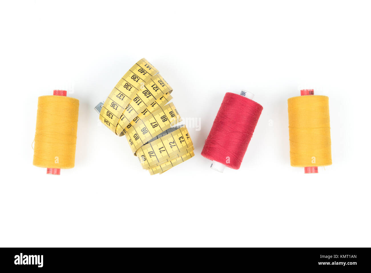 Sewing thread coil with yellow measuring tape on white background Stock ...