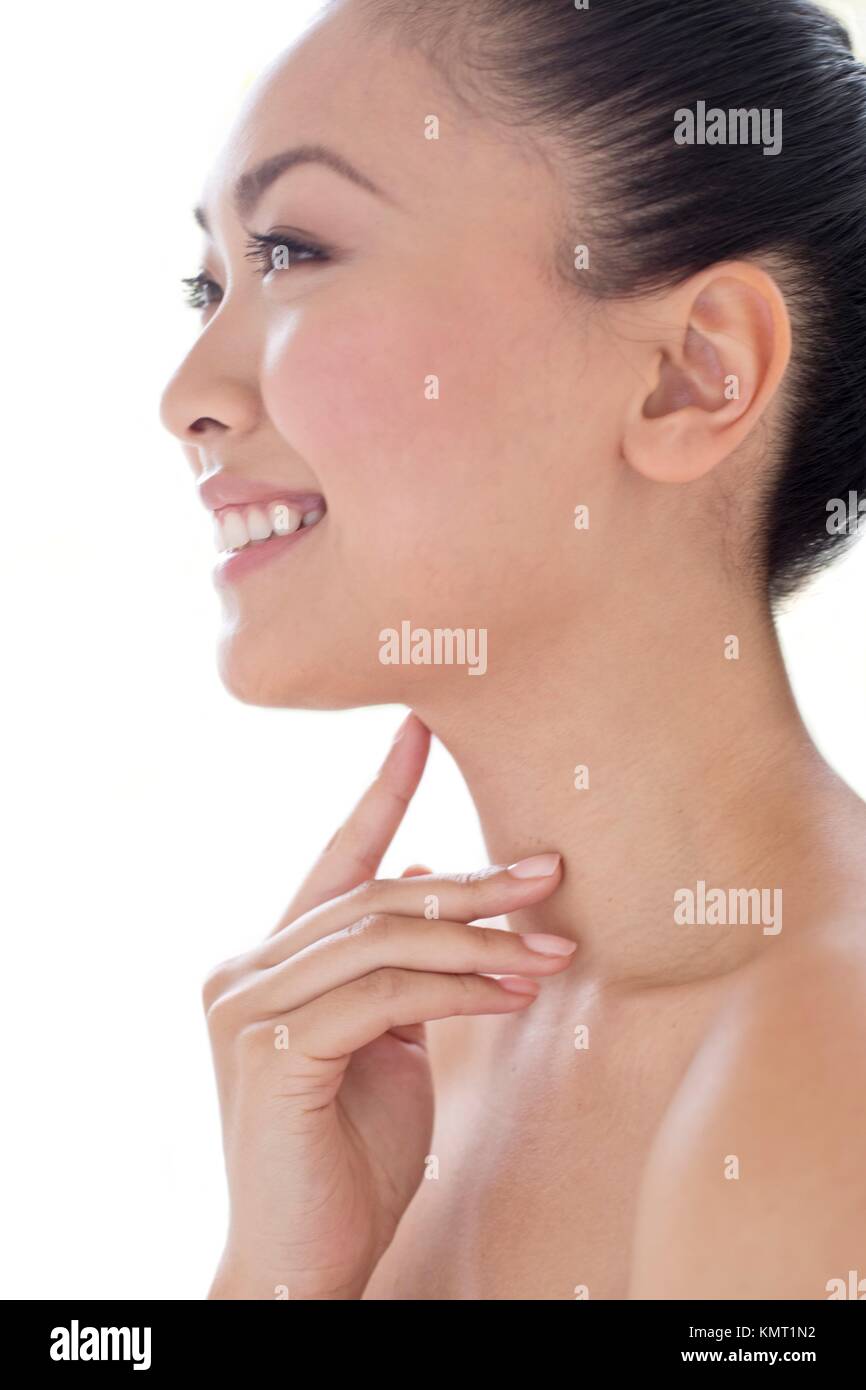 Young woman touching neck,portrait Stock Photo - Alamy