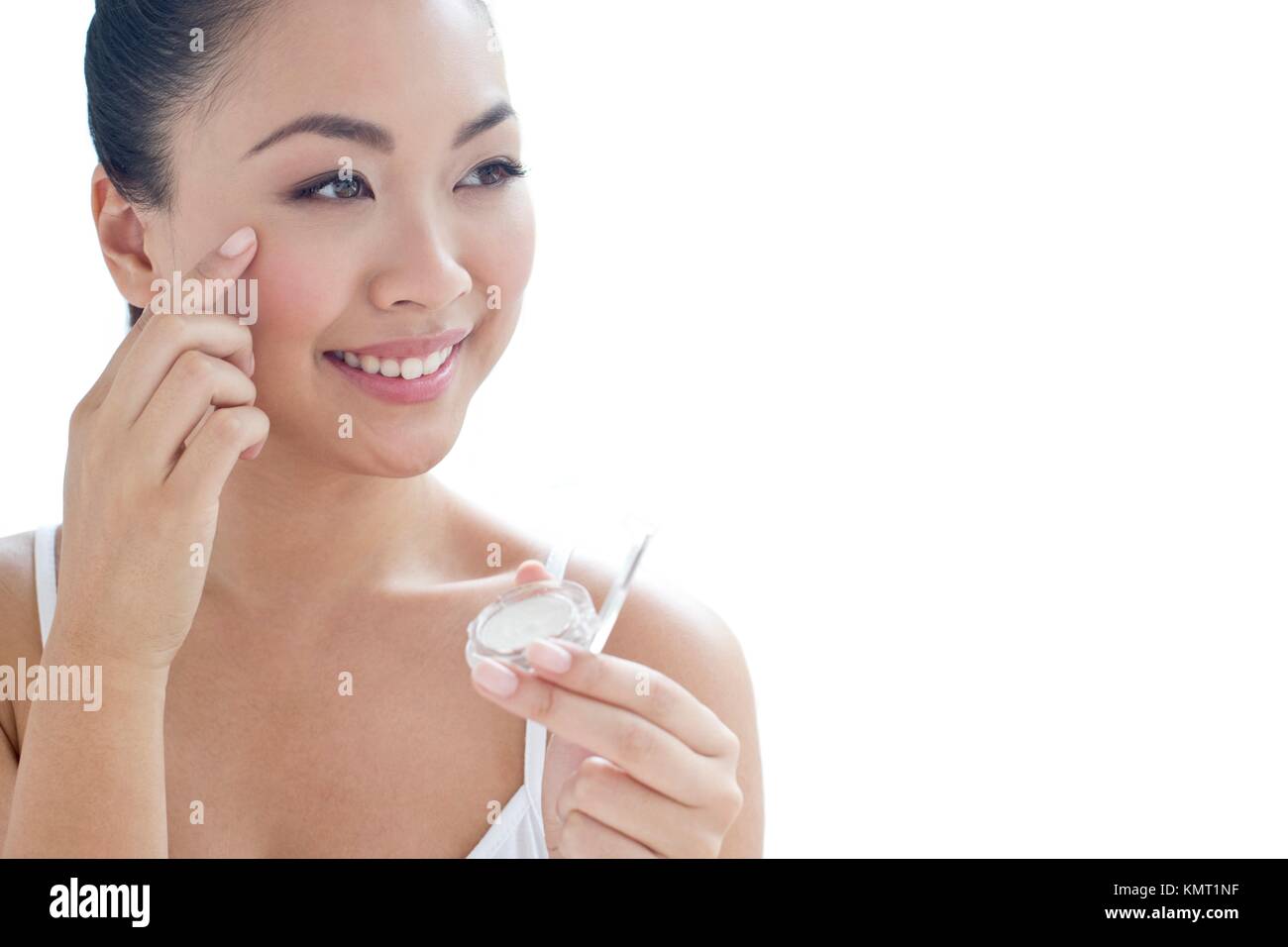 Young woman applying face cream,portrait Stock Photo - Alamy