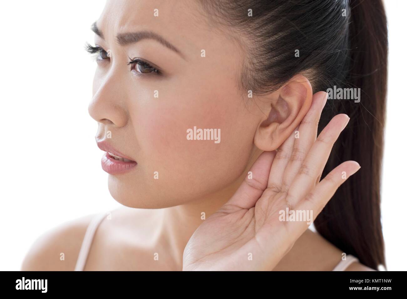 Young woman with hand behind ear,portrait Stock Photo - Alamy