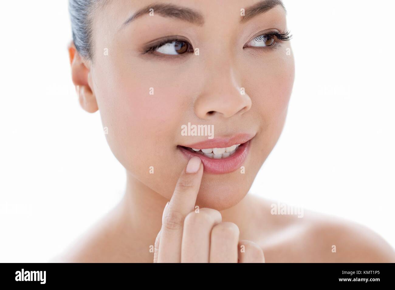 Young woman touching lip,portrait Stock Photo - Alamy
