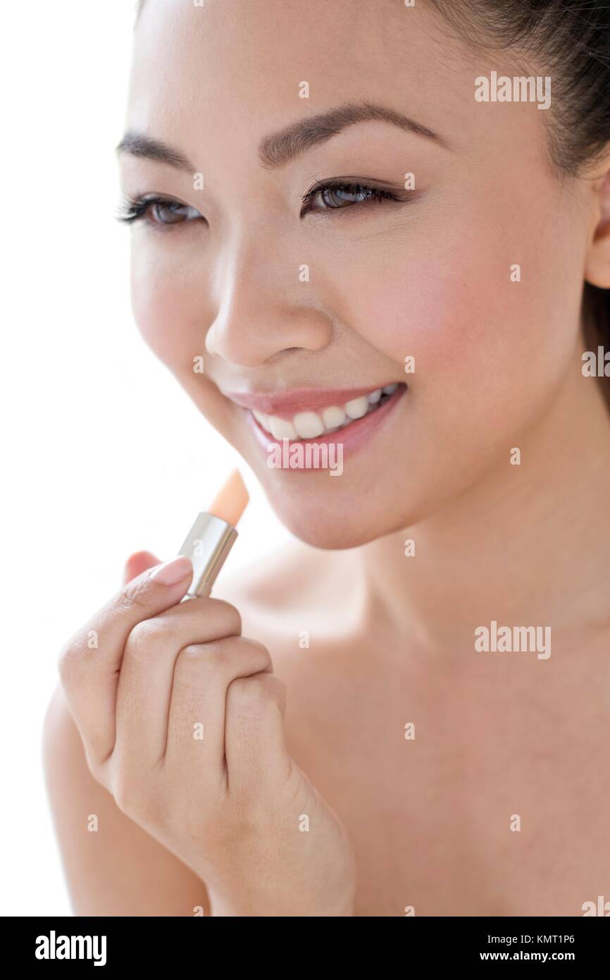 Young woman applying lipstick.portrait Stock Photo - Alamy