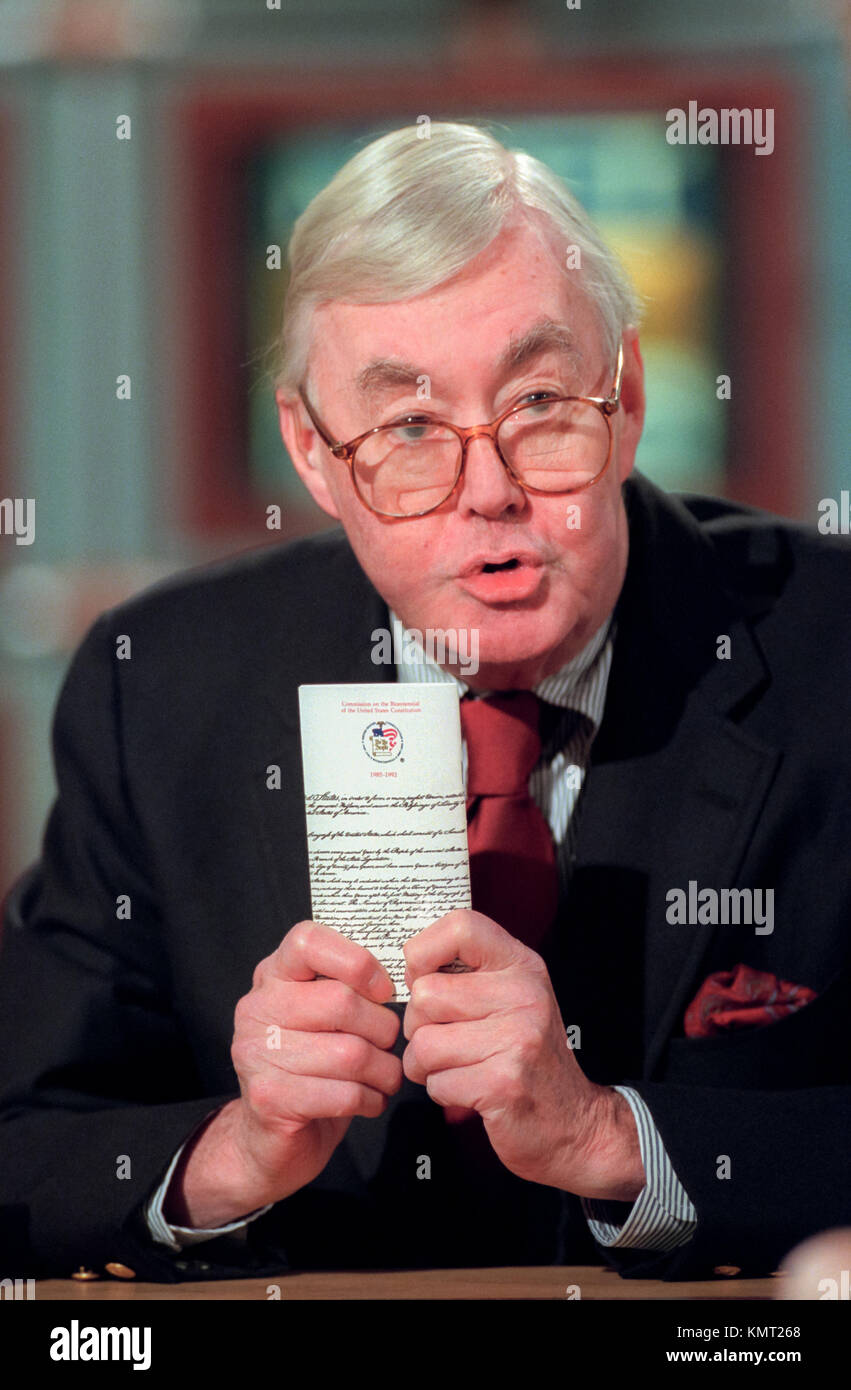 Senator Daniel Patrick Moynihan holds a copy of the US Constitution as ...
