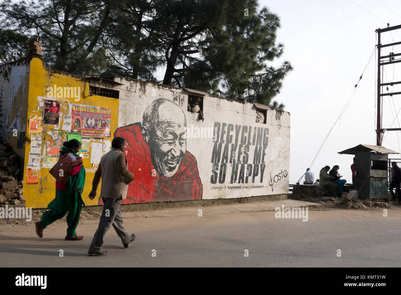 People walk past mural depicting Tibetan monk promoting recycling, in ...